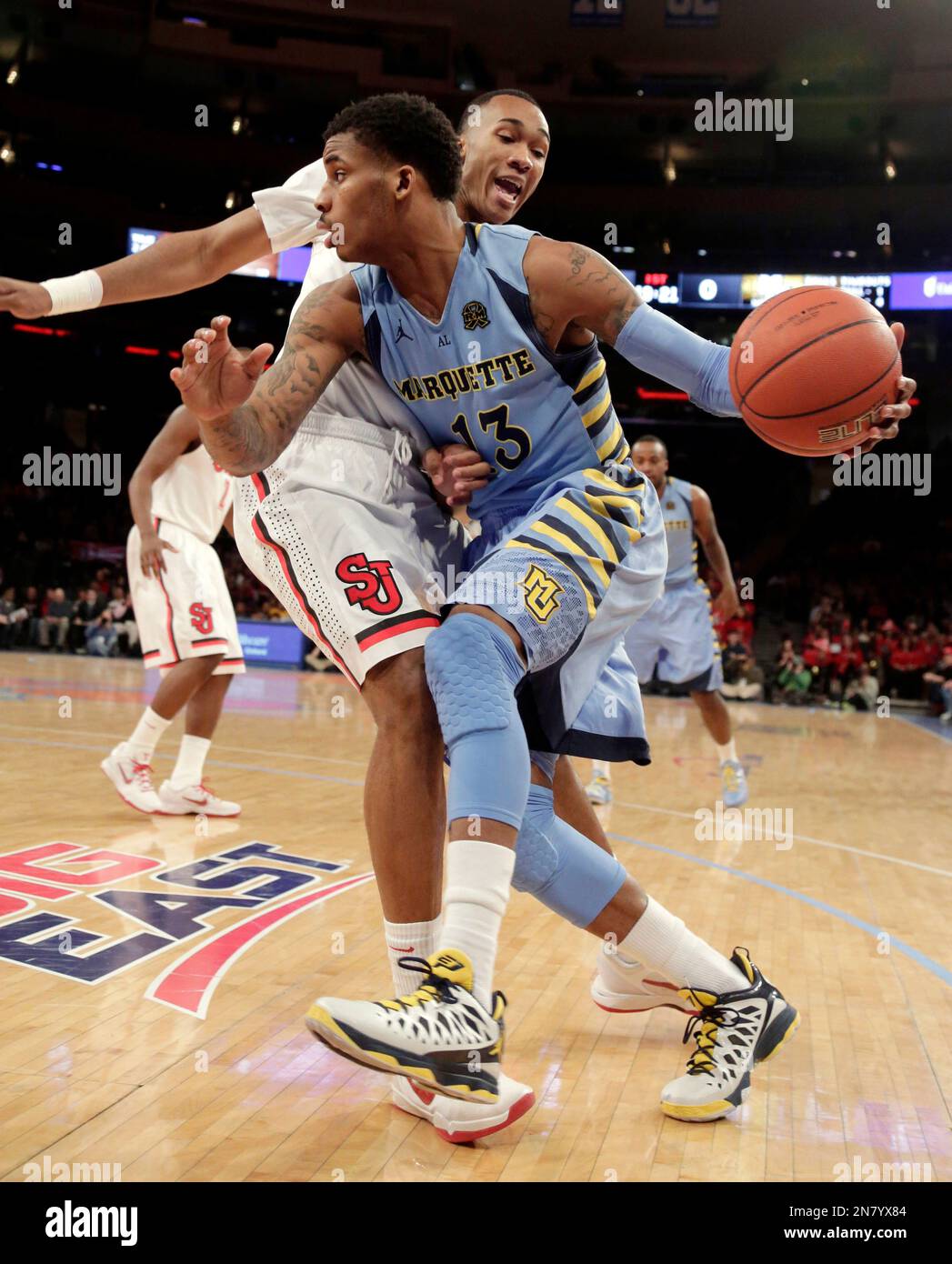 Marquette's Vander Blue, right, drives against St. John's Amir Garrett ...