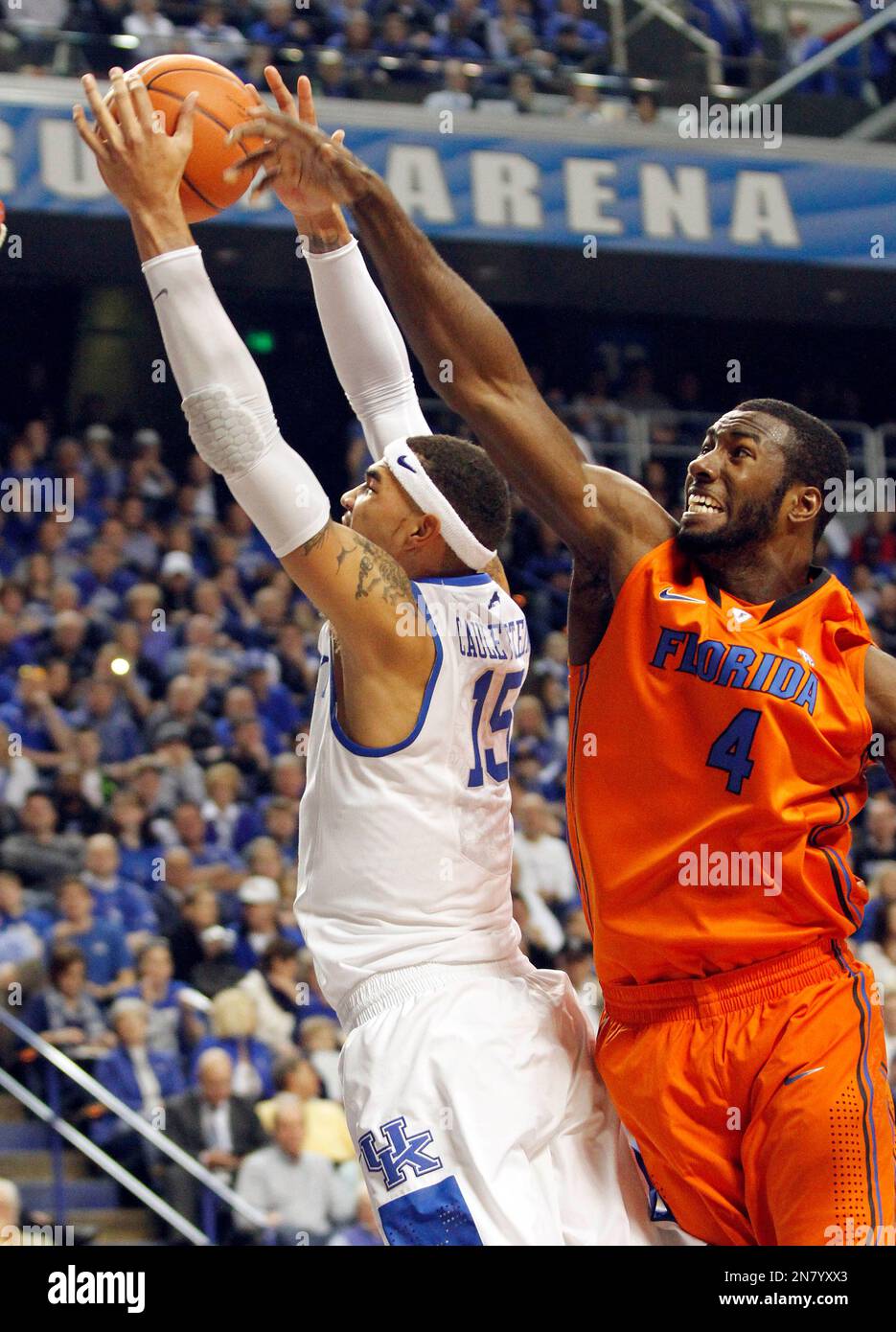 Kentucky's Willie Cauley-Stein, left, shoots as Florida's Patric Young ...
