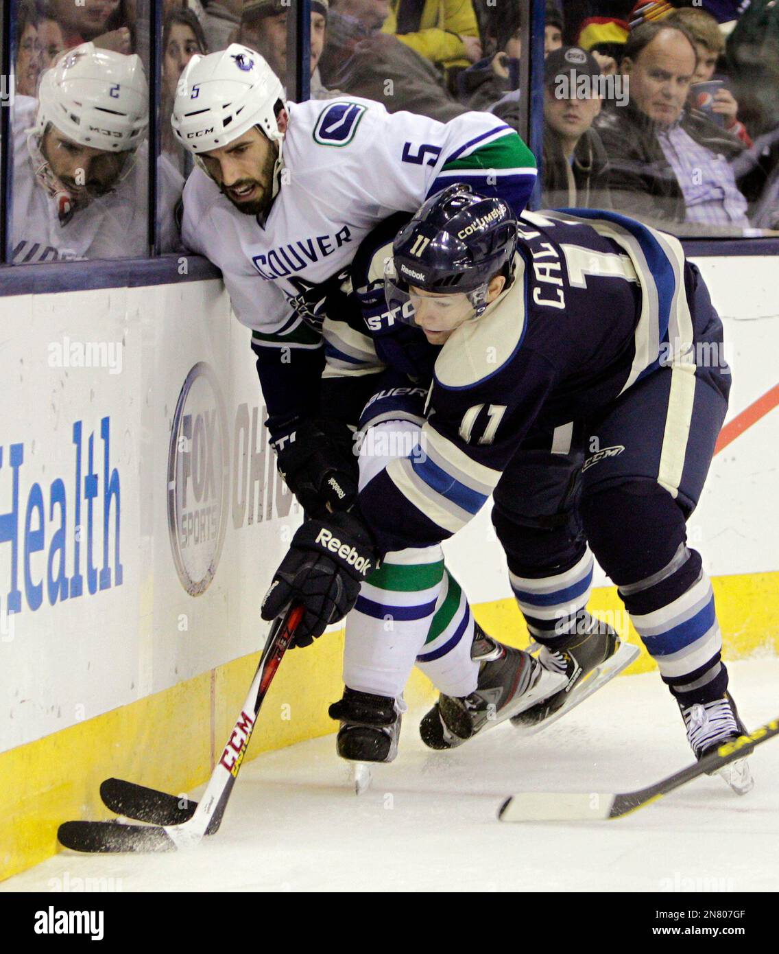 Vancouver Canucks' Jason Garrison, left, and Columbus Blue Jackets ...