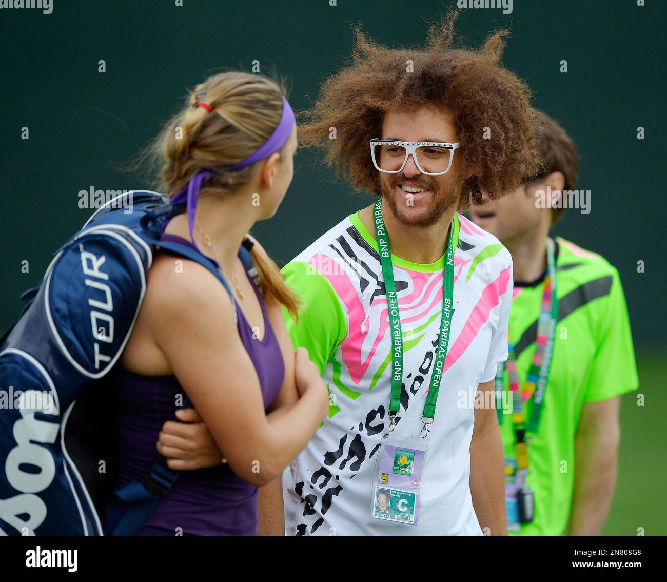 Performer Redfoo, right, of the dance music duo LMFAO, walks with his ...