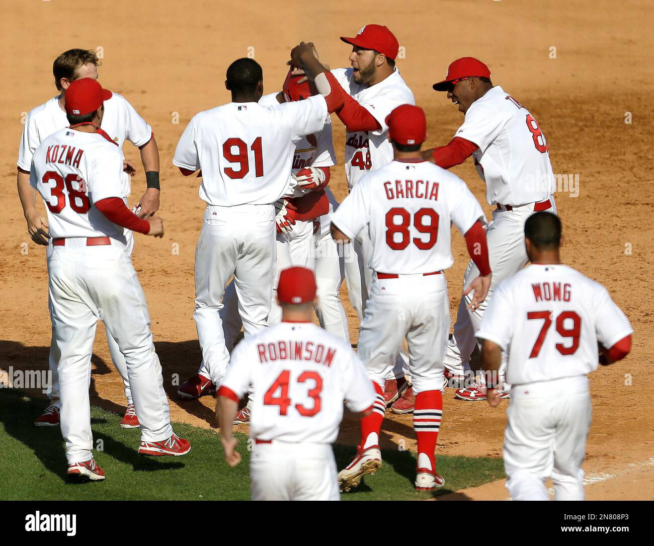 St. Louis Cardinals players mob Adron Chambers, top center, after he ...