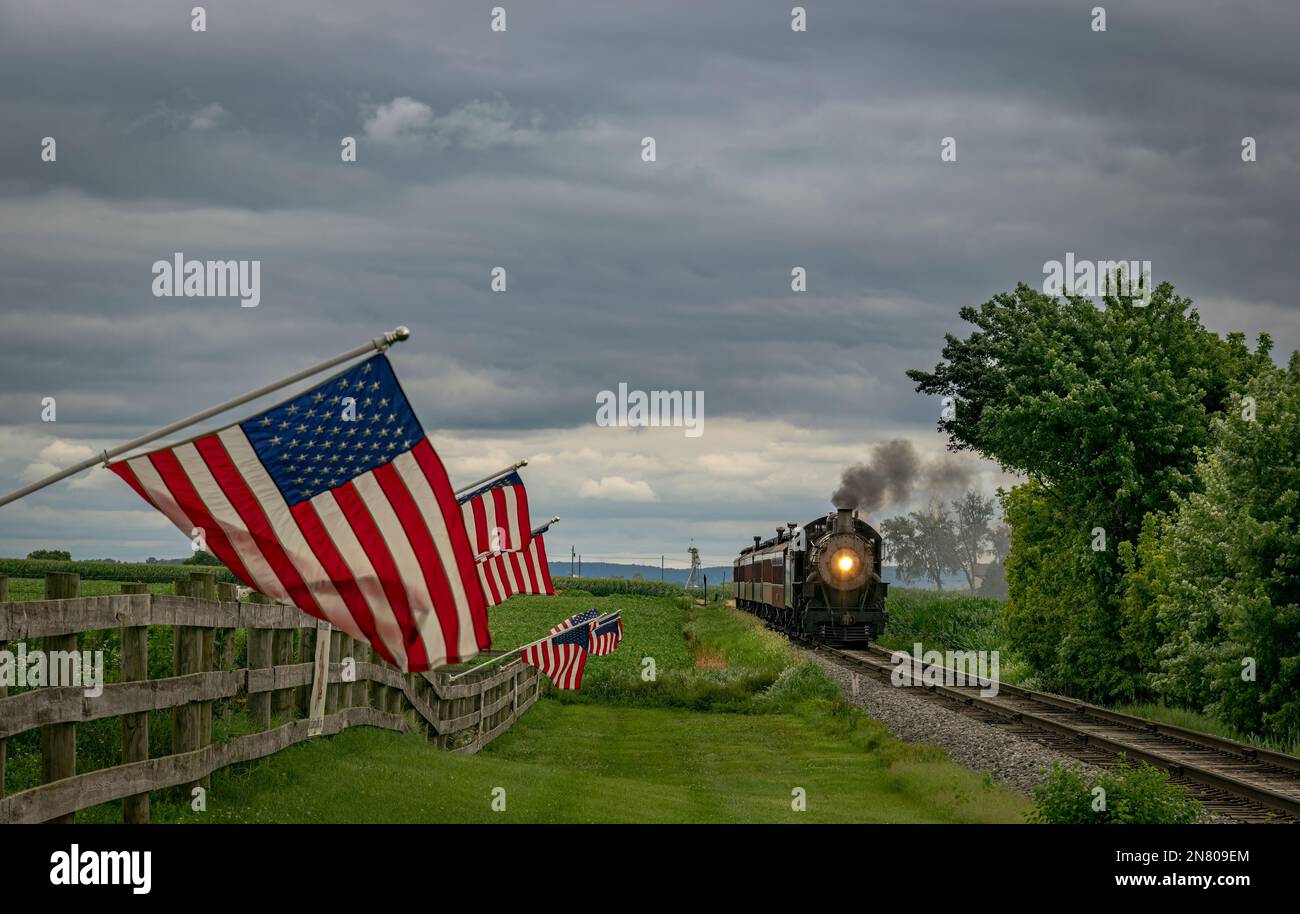On a Cloudy Day American Flags are Waving in the Wind, on a Fence ...