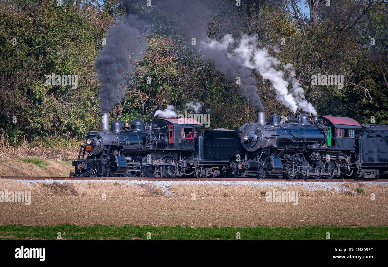 A View of Two Steam Engines, blowing Smoke and Steam Warming Up Next to ...