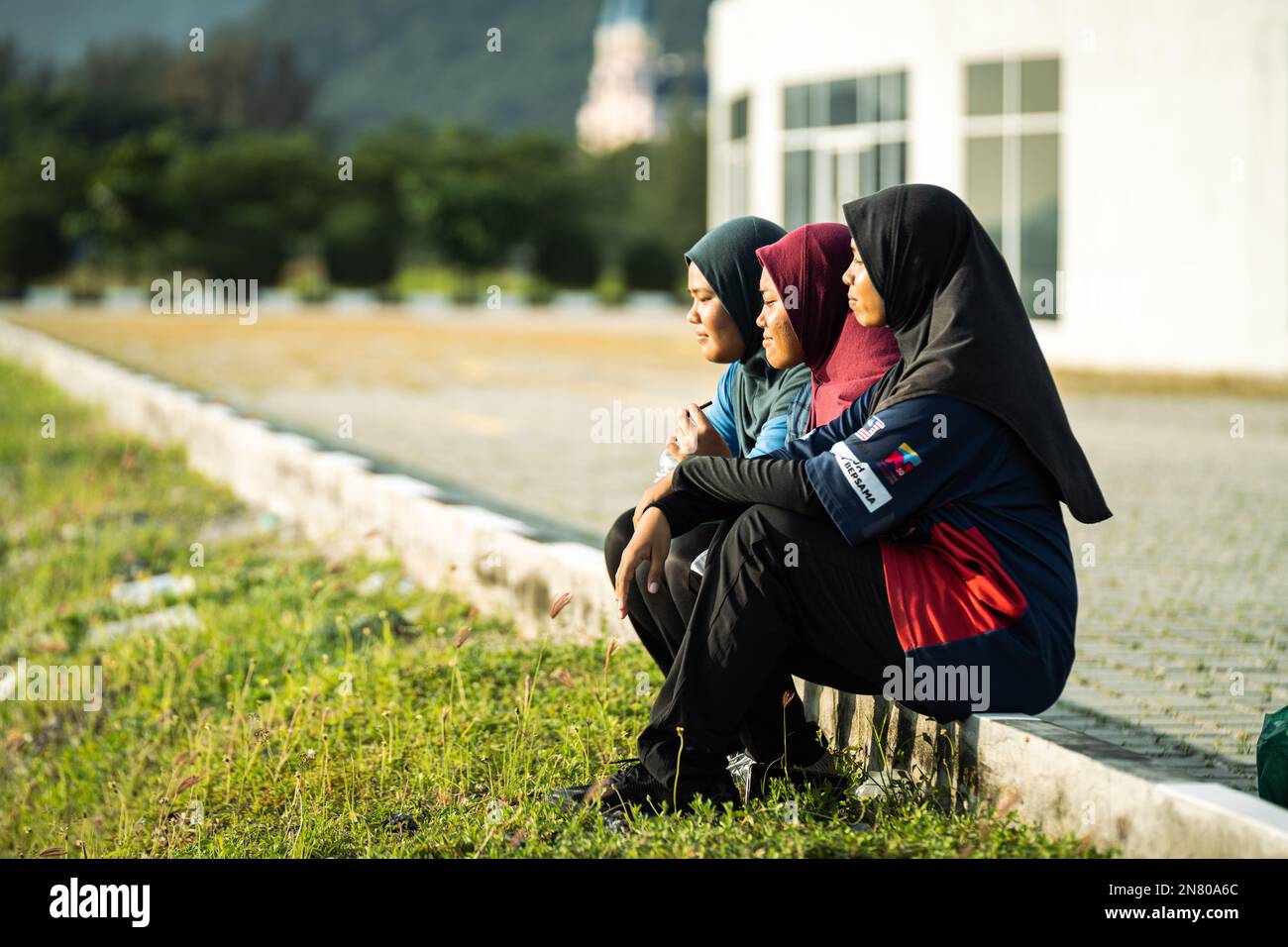 A view of three muslim girls enjoying sunset in field Stock Photo - Alamy