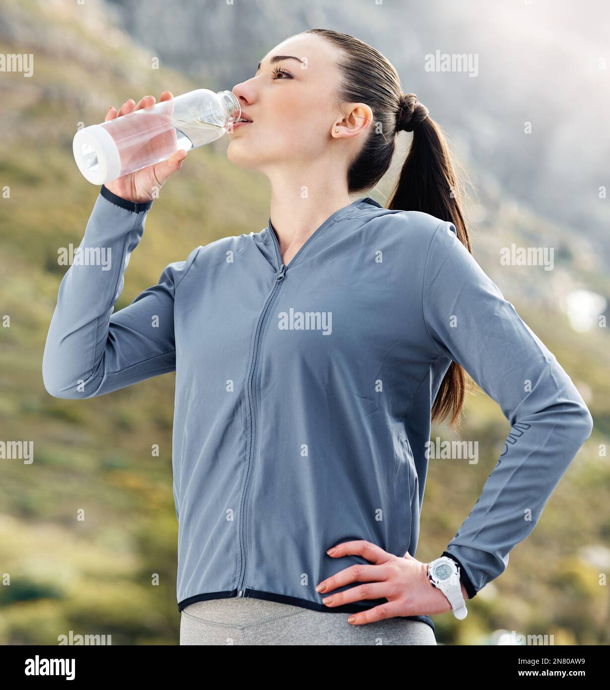 A healthy outside starts from the inside. a woman drinking water while ...