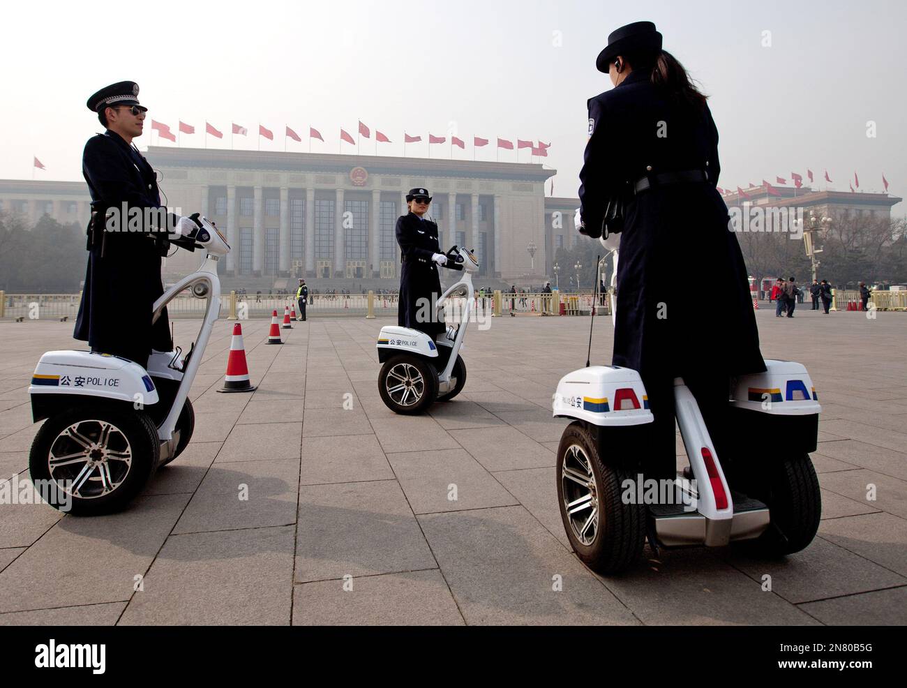 Chinese police officers on electric two-wheel vehicles patrol on ...