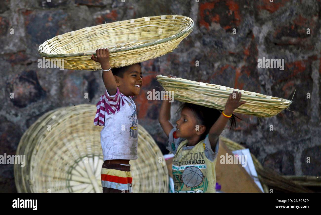 Indian children carry wicker baskets, made by their parents, to display ...