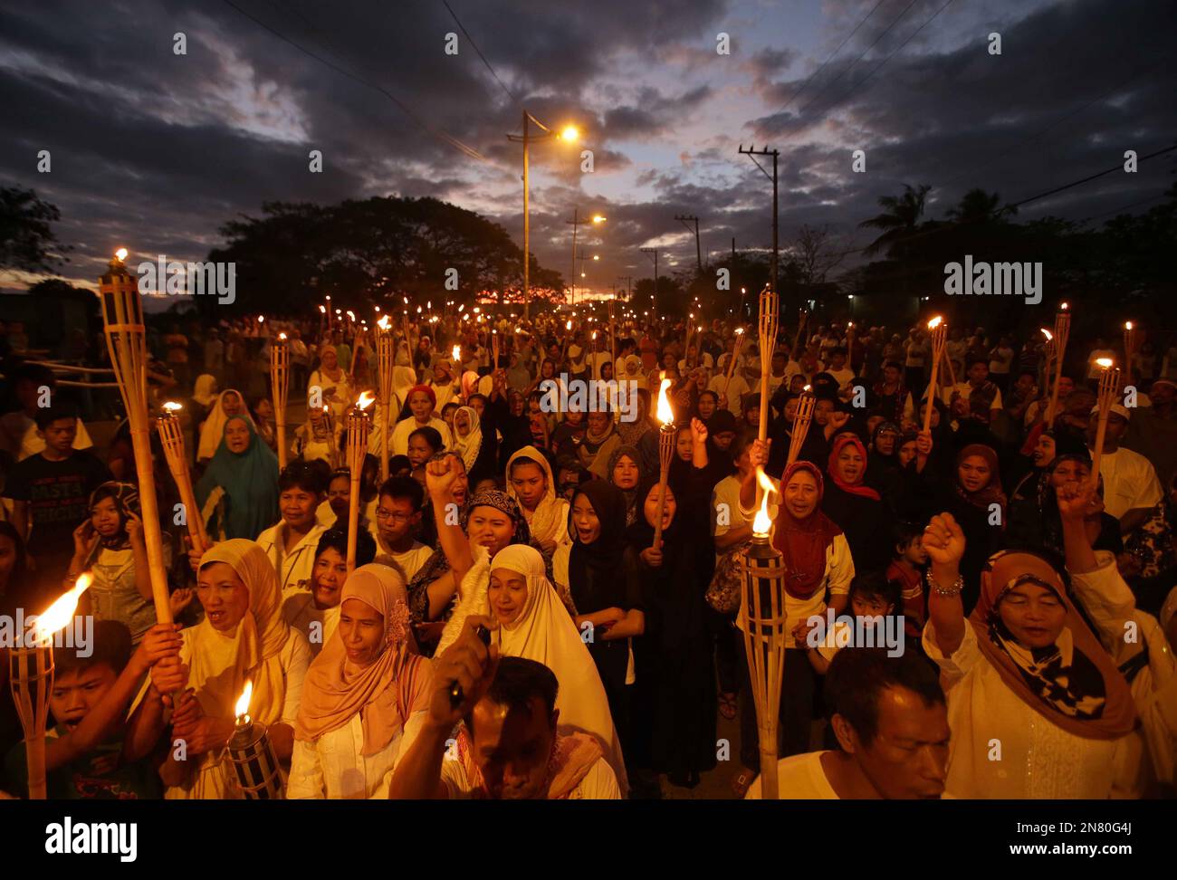 Filipino Muslim women carry torches as they join a rally at the ...