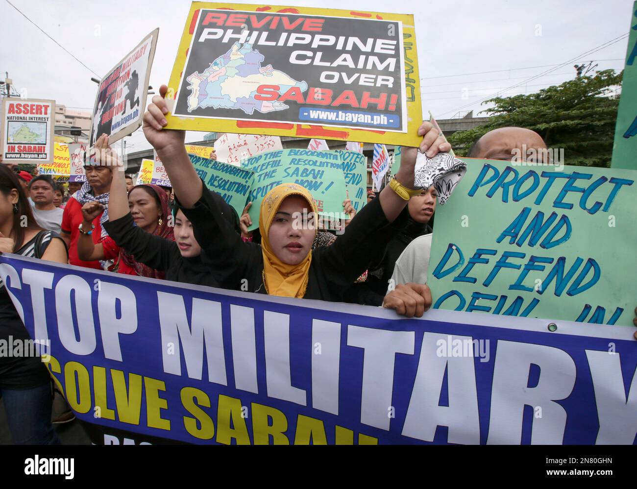 Filipino Muslims are joined by other protesters as they march towards ...