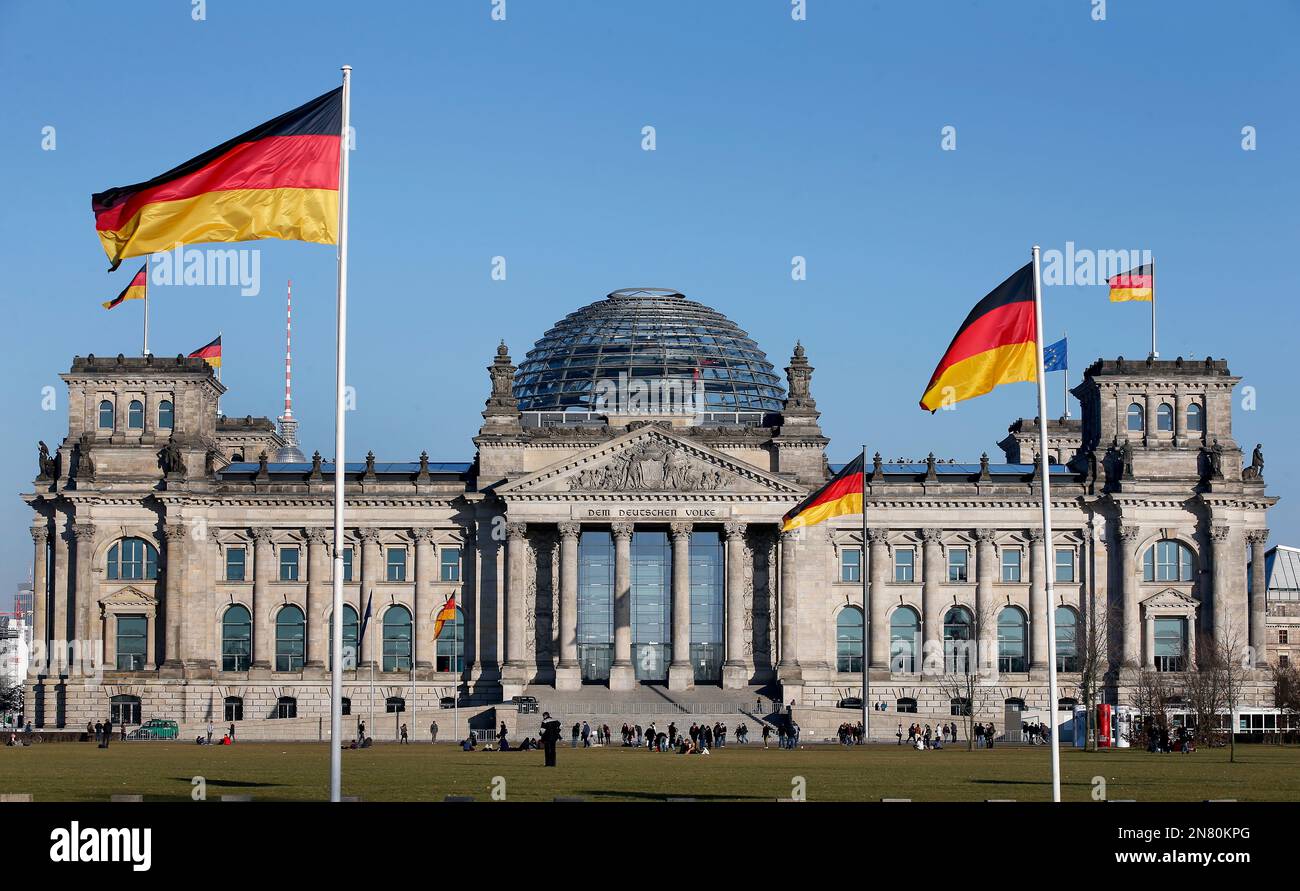 German flags wave in front of the Reichstag building, host of the ...