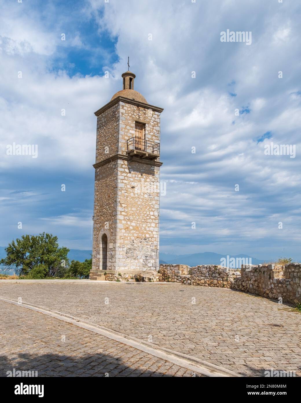 Old stone clock tower atop a hill in Nafplio Greece Stock Photo - Alamy