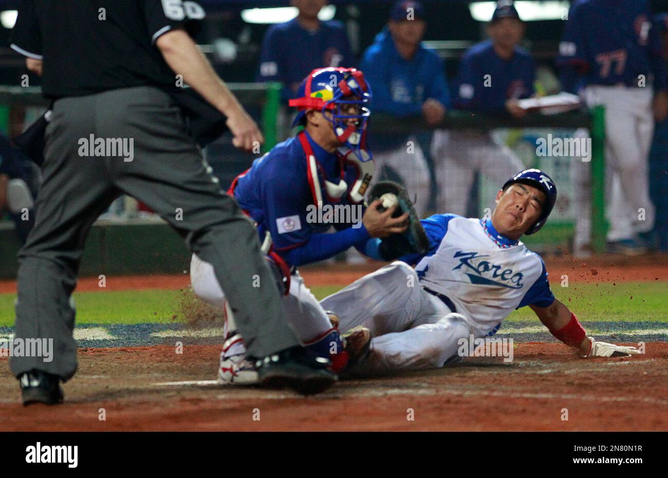 South Korea's second baseman Jeong Keunwoo, right, is tagged out at ...