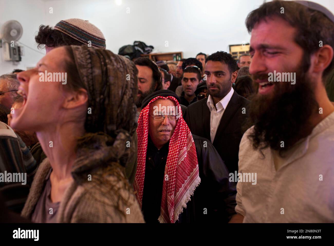 A Palestinian man, center, attends the funeral of Jewish Rabbi Menachem ...