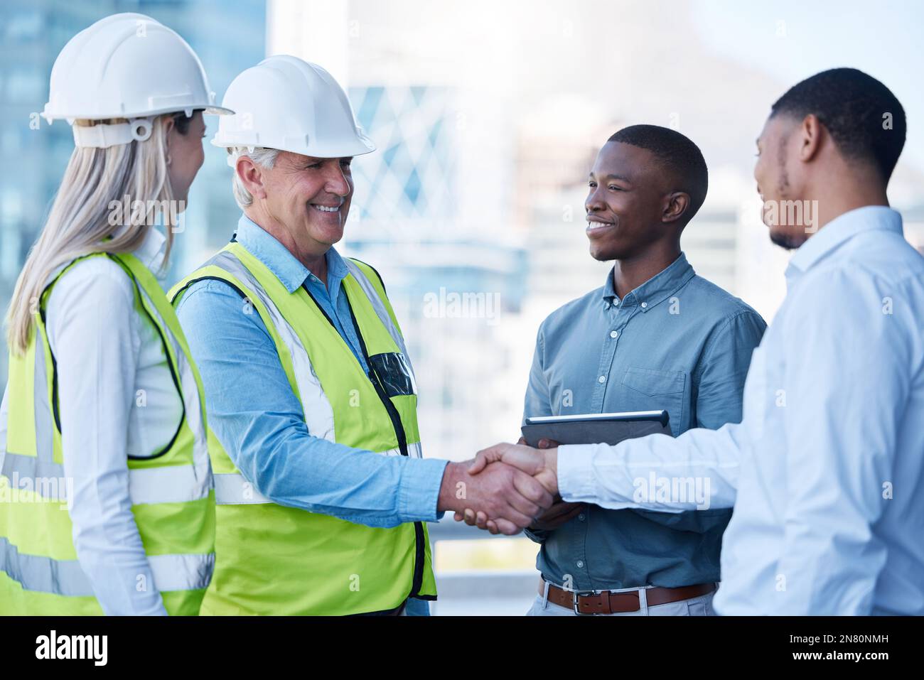 Your help is always welcome. a team of builders shaking hands in ...