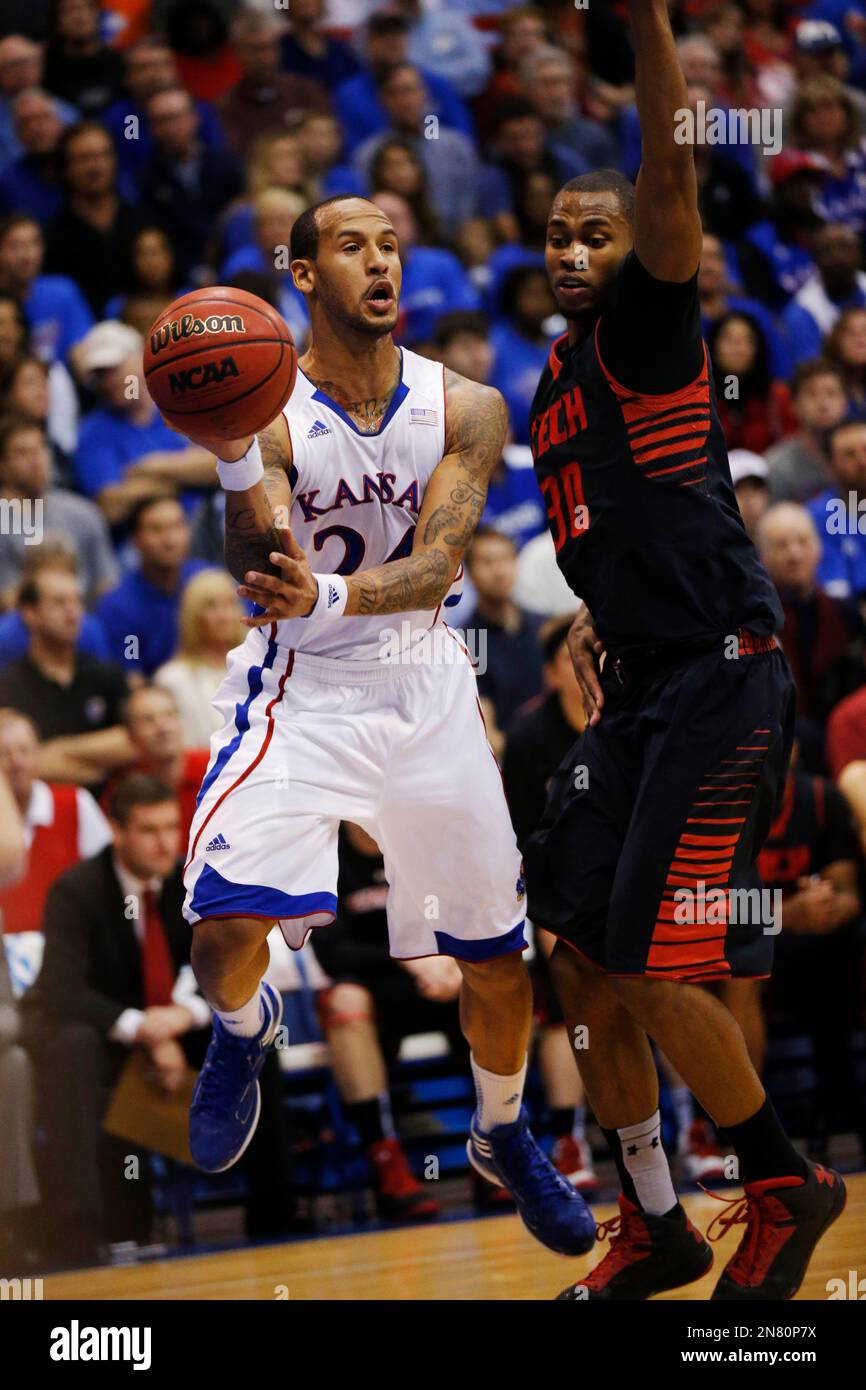 Kansas guard Travis Releford (24) and Texas Tech forward Jaye Crockett ...