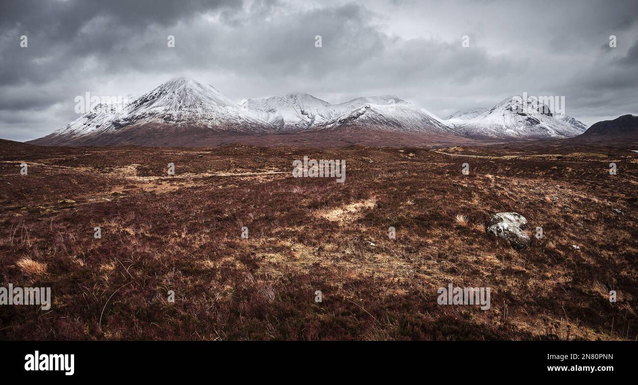 Isle of Skye, Scotland - Panoramic view of the snowy mountains of Glamaig on a cloudy spring day ...