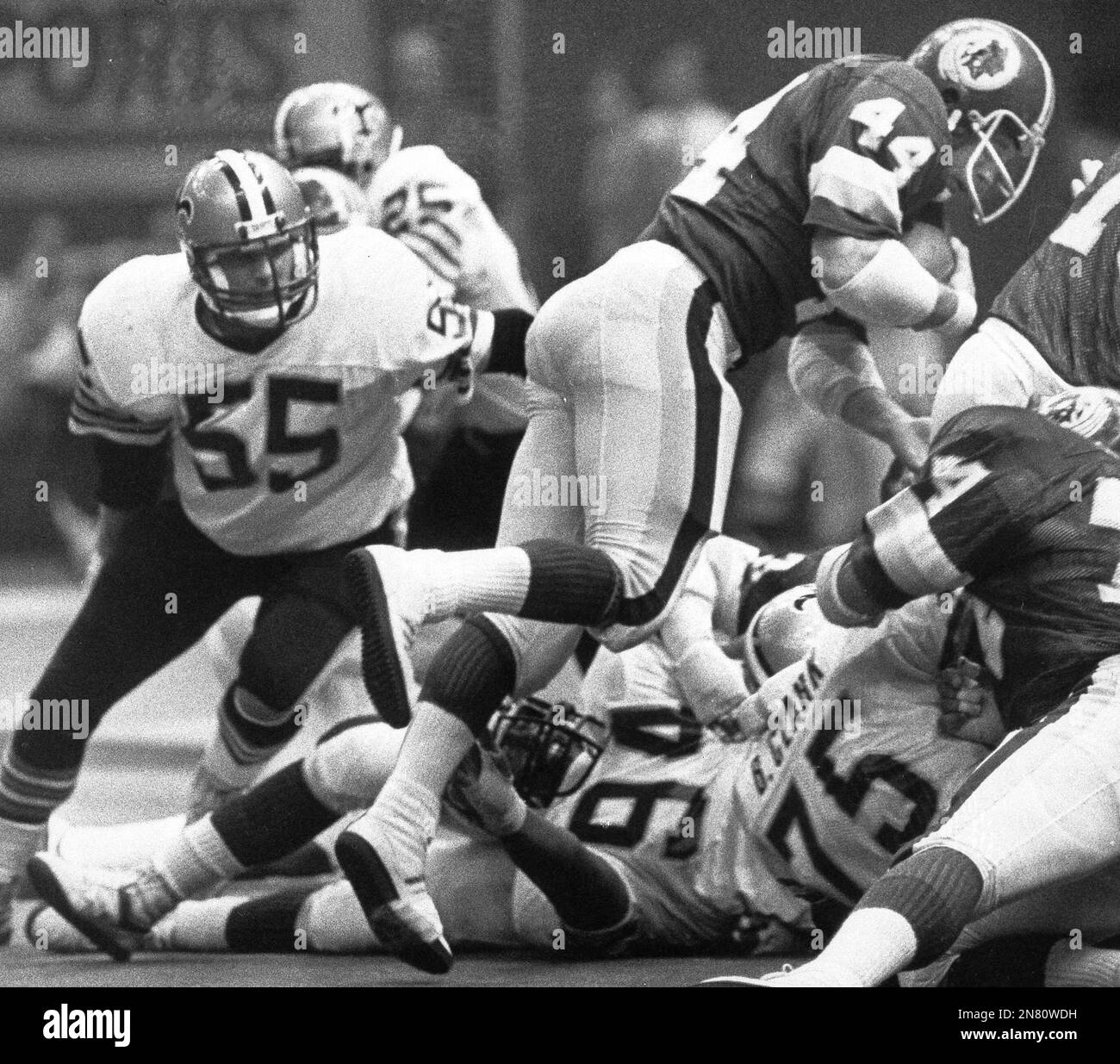 Washington Redskins' running back John Riggins (44) goes over grounded ...