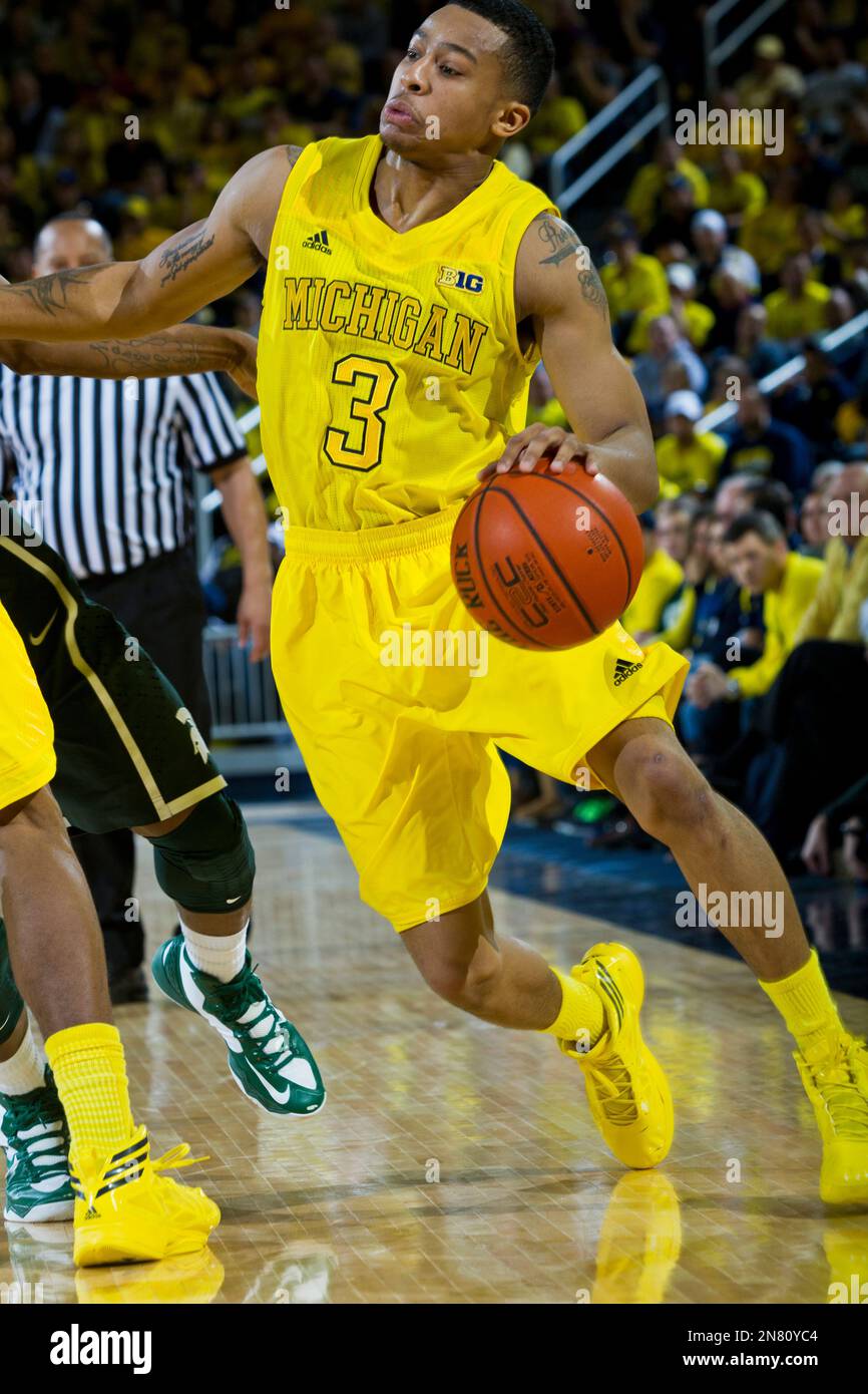 Michigan guard Trey Burke (3) dribbles in the second half of an NCAA ...