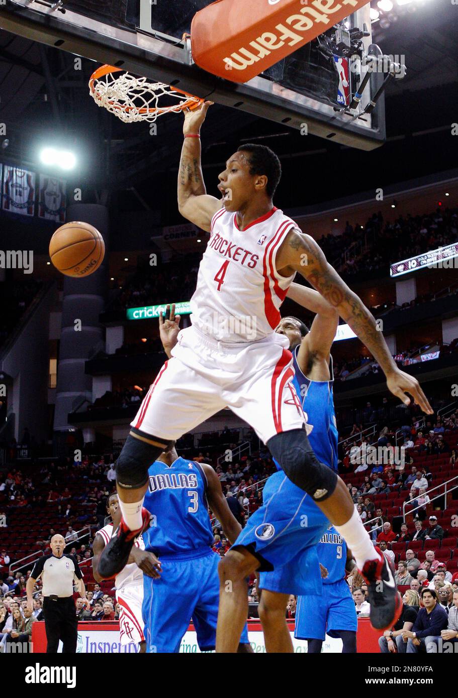 Houston Rockets forward Greg Smith (4) dunks on Dallas Mavericks center Brandan Wright during ...