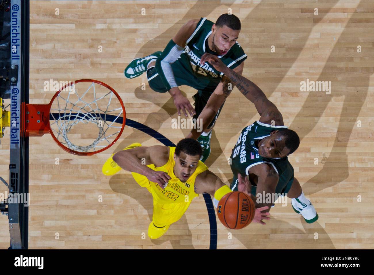 Michigan forward Jordan Morgan, bottom, wins a rebound from Michigan ...