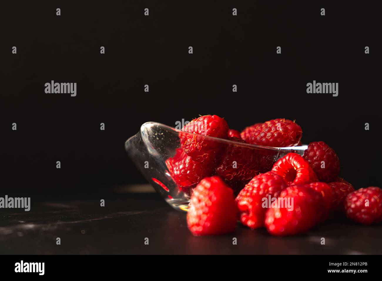 Normal view of a Serving of Raspberries in a small clear bowl on a ...