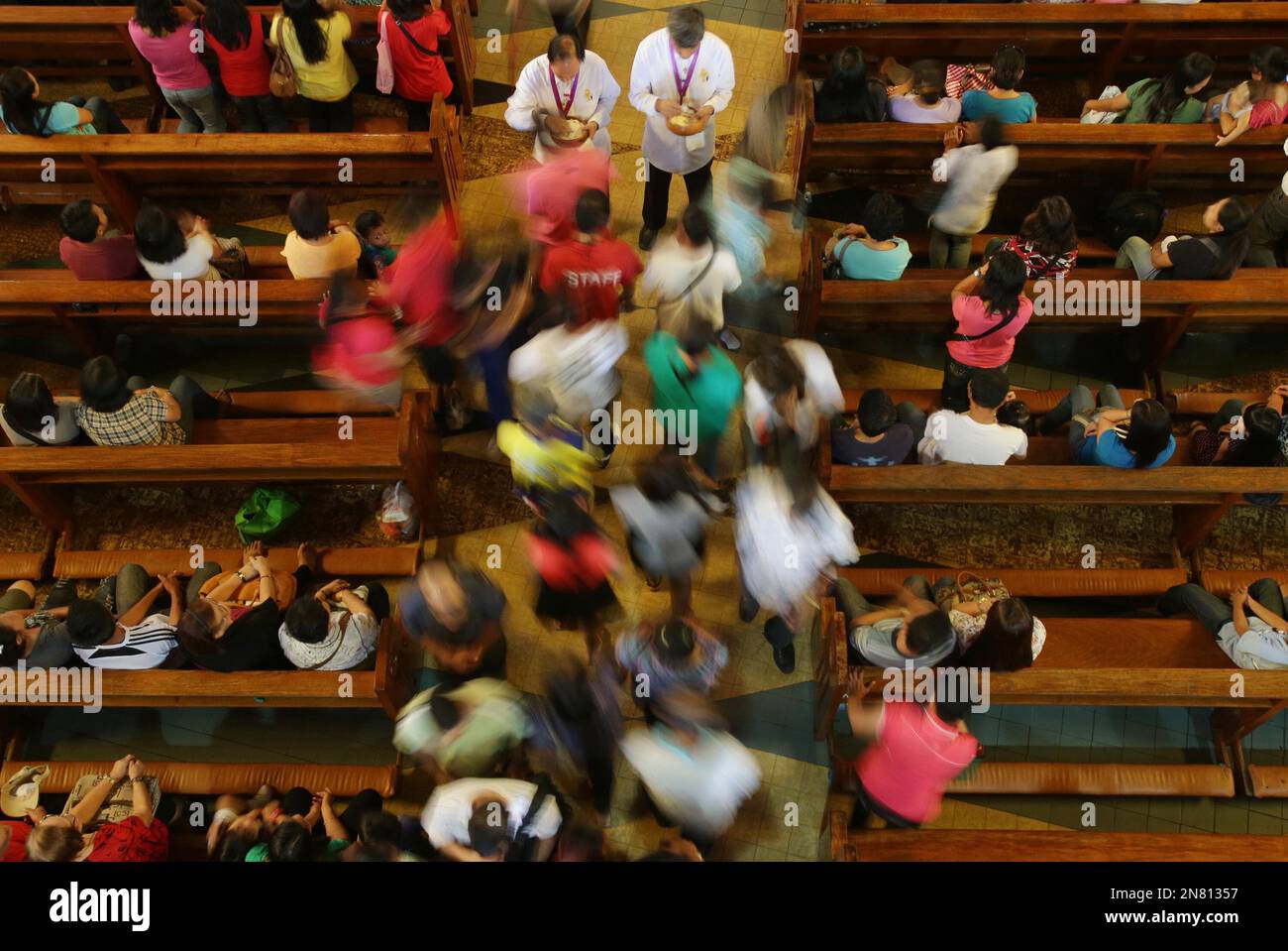 Filipino Catholics receive communion during a mass at the Shrine of Our ...