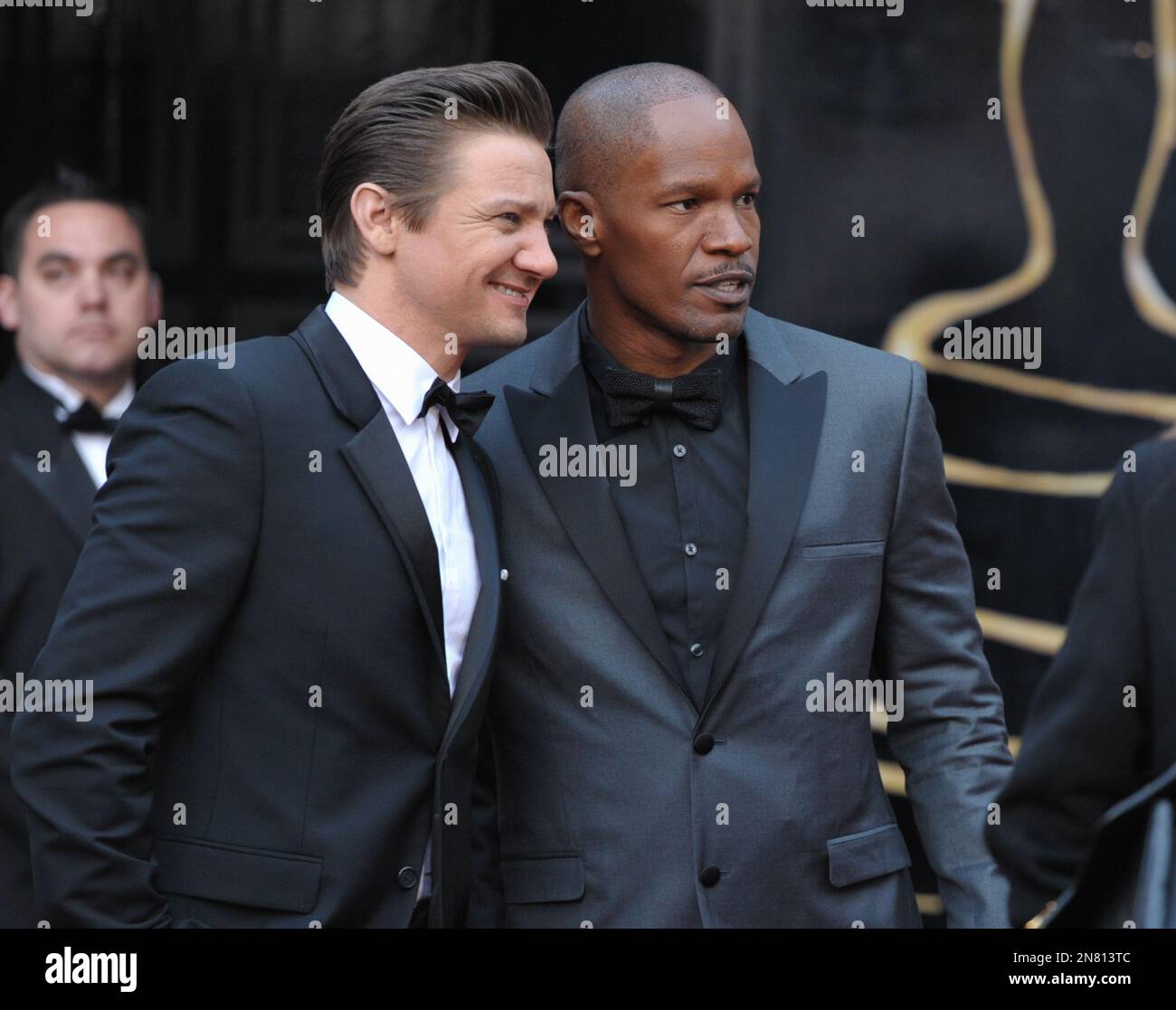 Actors Jeremy Renner, left, and Jamie Foxx arrive at the Oscars at the ...