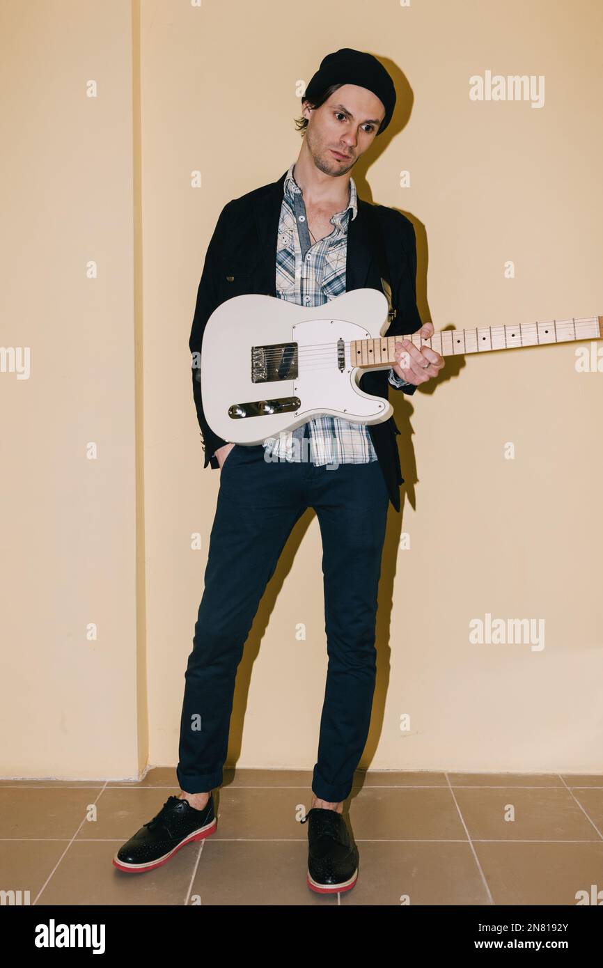 Male hipster posing with electric guitar Stock Photo - Alamy