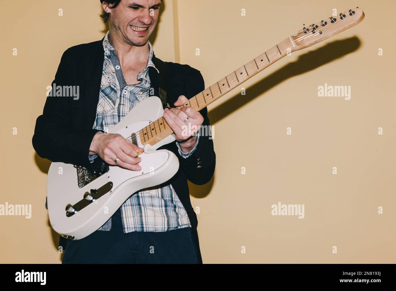 Adult guitarist enthusiastically playing guitar Stock Photo - Alamy