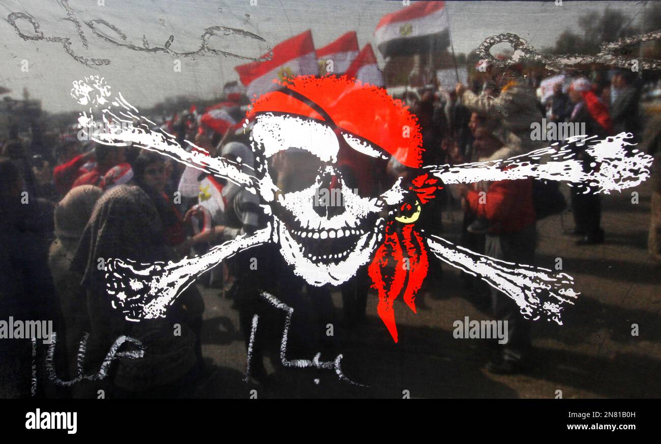 Egyptian pro-military supporters are seen through a transparent pirate ...