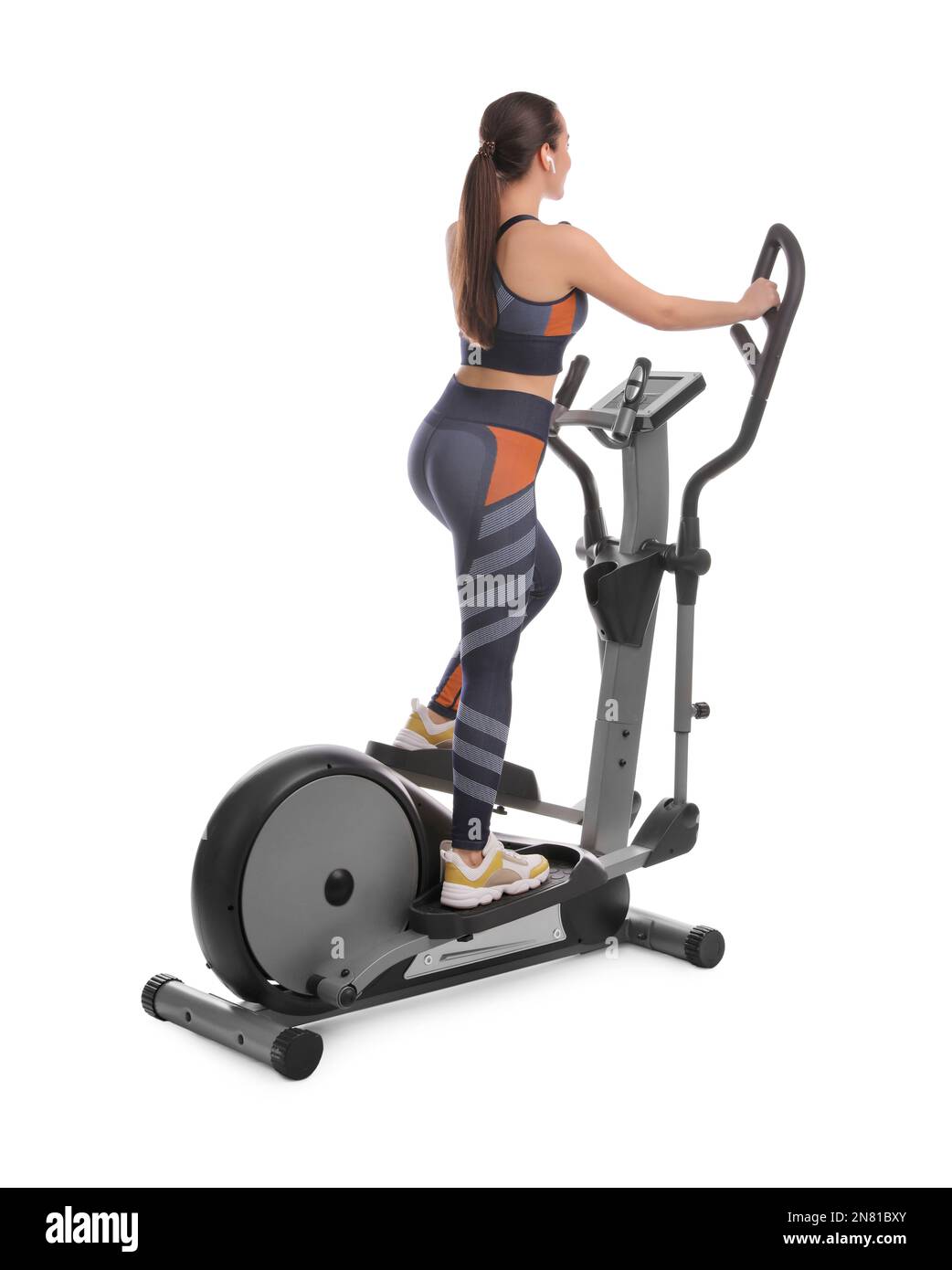 Woman using modern elliptical machine on white background Stock Photo ...