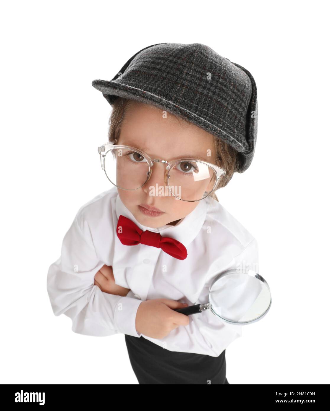 Cute little child in hat with magnifying glass playing detective on ...