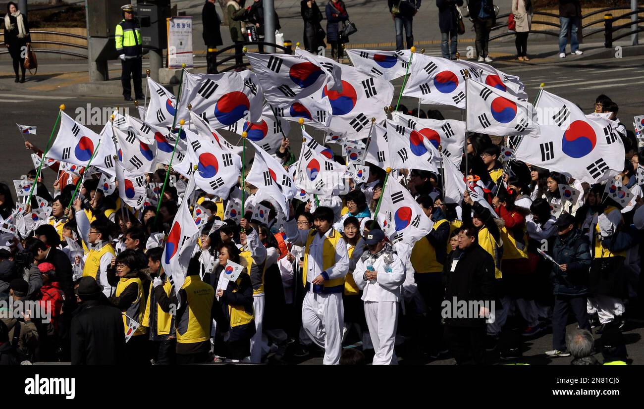 South Koreans wearing traditional Korean costumes carry their national ...