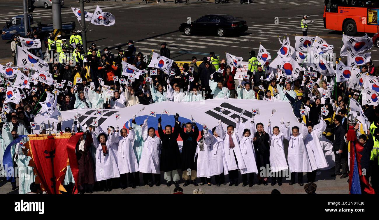 South Koreans wearing traditional Korean costumes carry a huge national ...