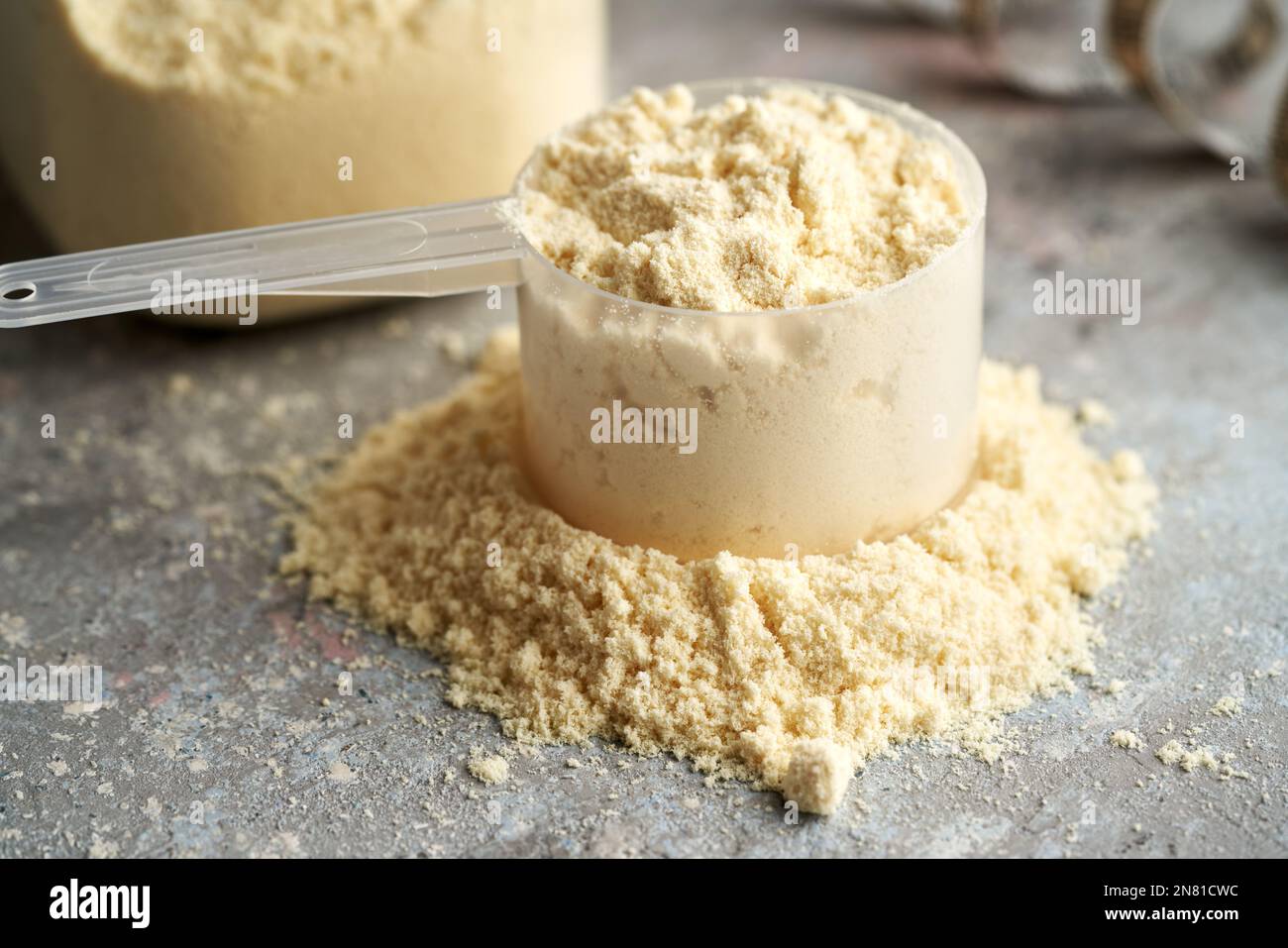 Whey protein powder in a plastic measuring spoon on a table Stock Photo ...