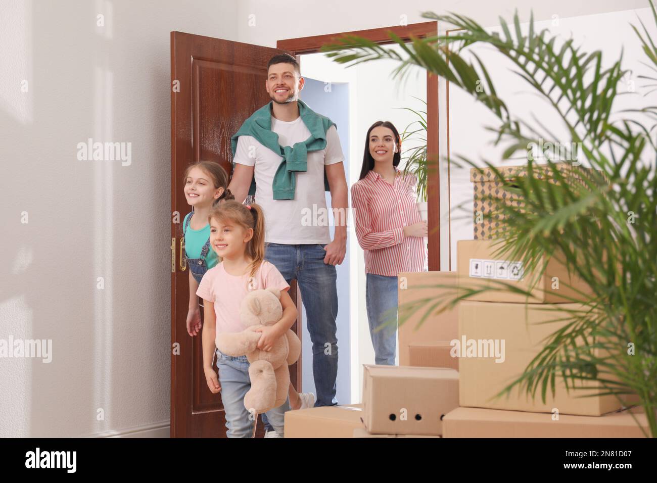 Happy family with children moving into new house Stock Photo - Alamy