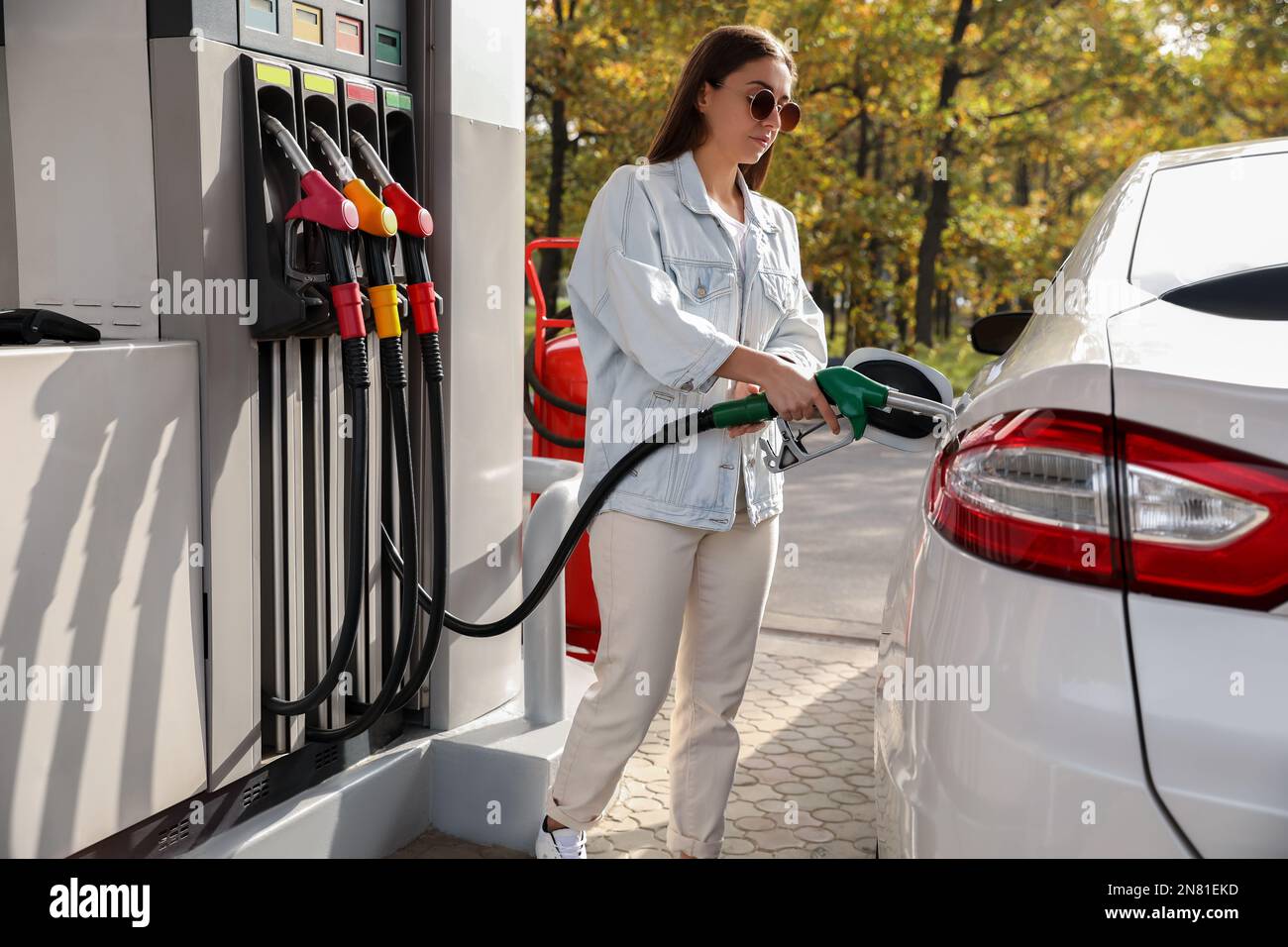 Woman refueling car at self service gas station Stock Photo - Alamy