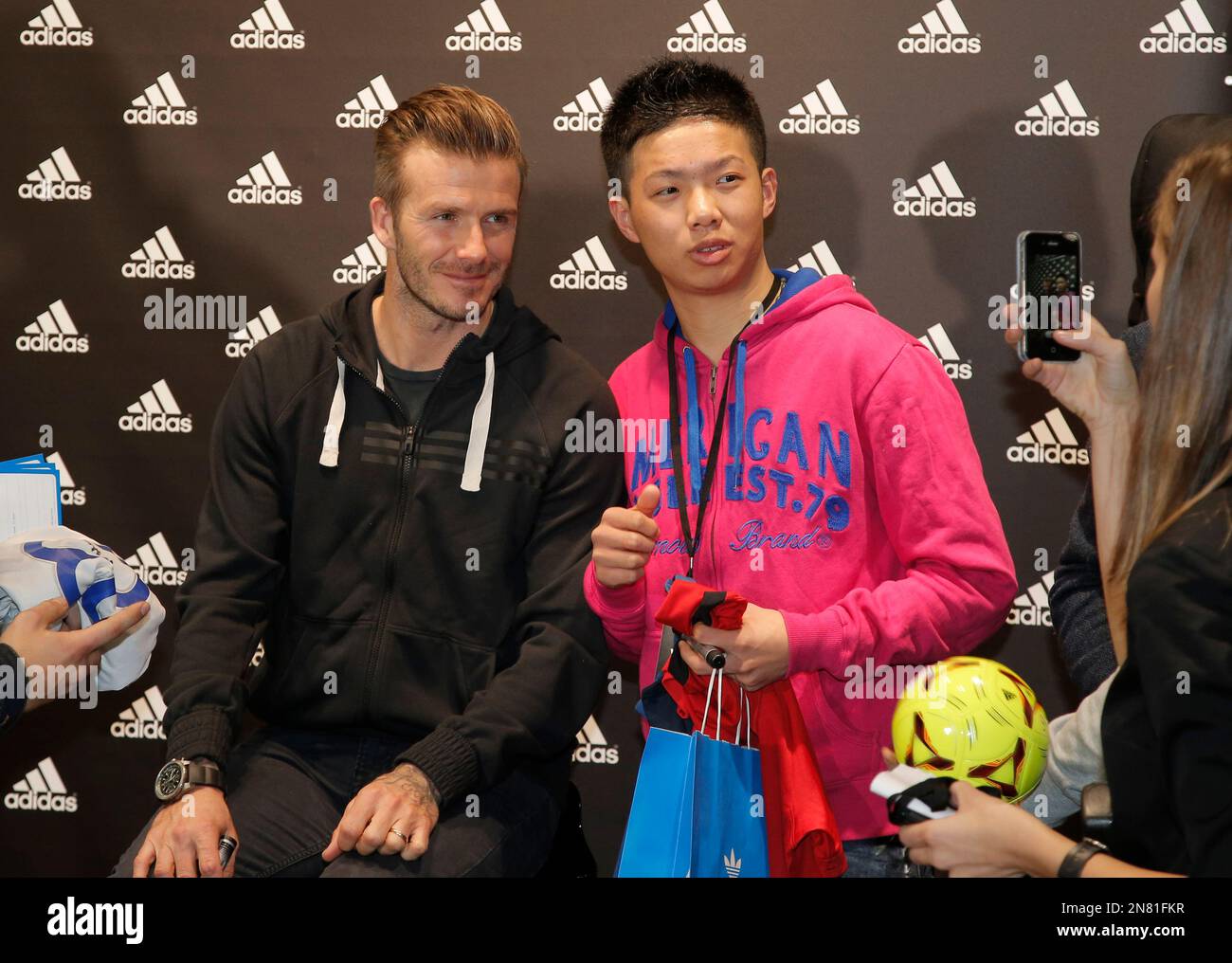 Paris Saint Germain's David Beckham poses for a photograph with an ...