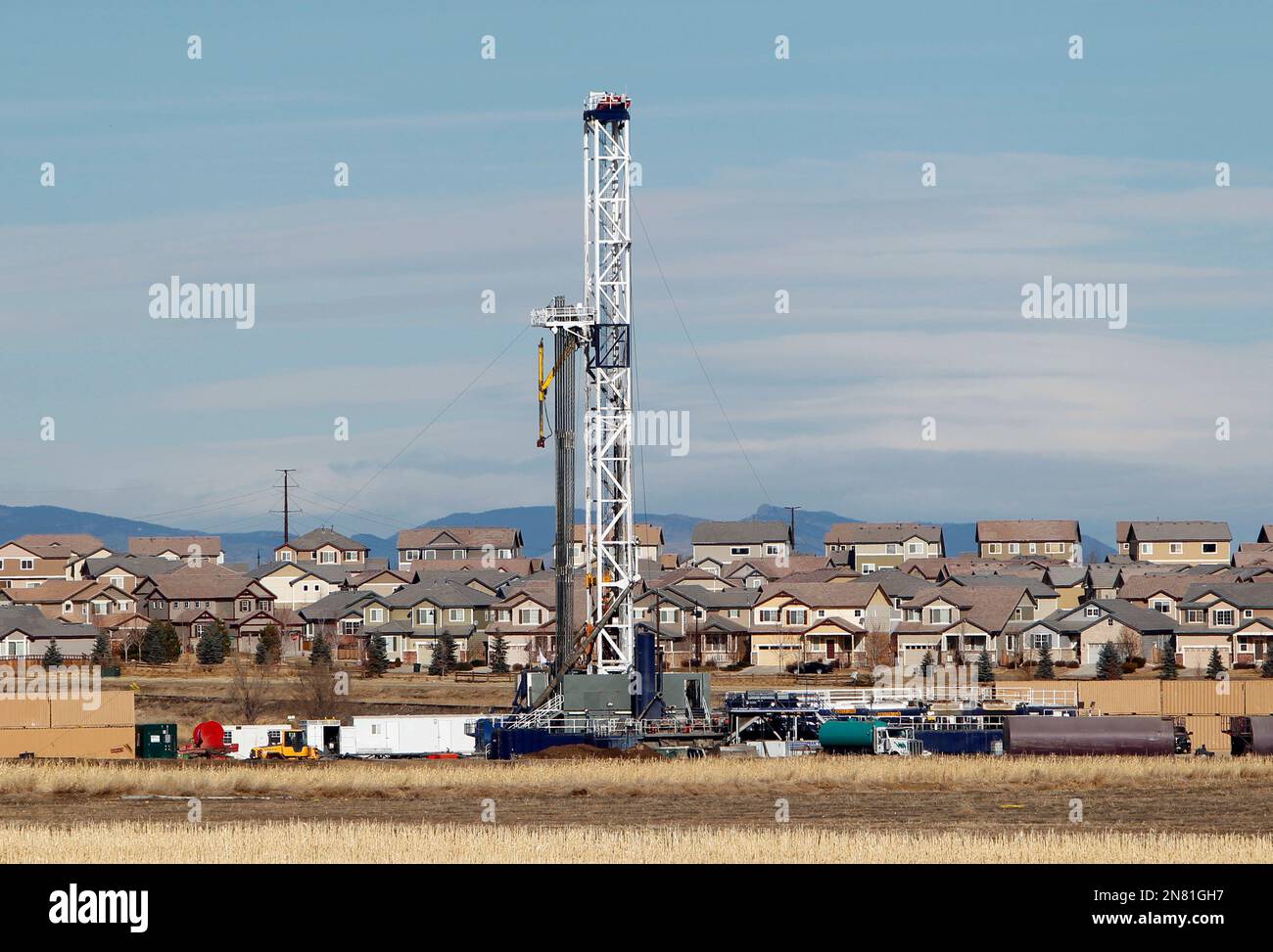 An oil well is drilled on a property across from a subdivision Thursday ...