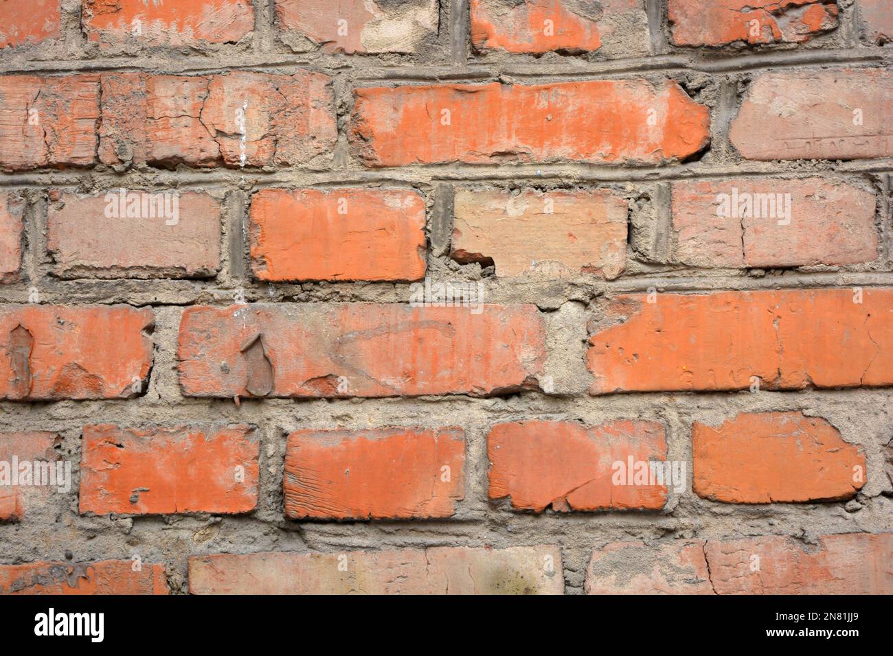 The building wall of one of the houses is built of old, solid red ...