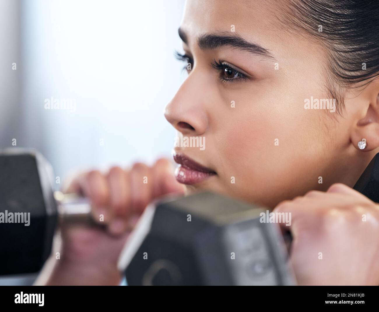Build your body, change your life. a young woman working out with ...