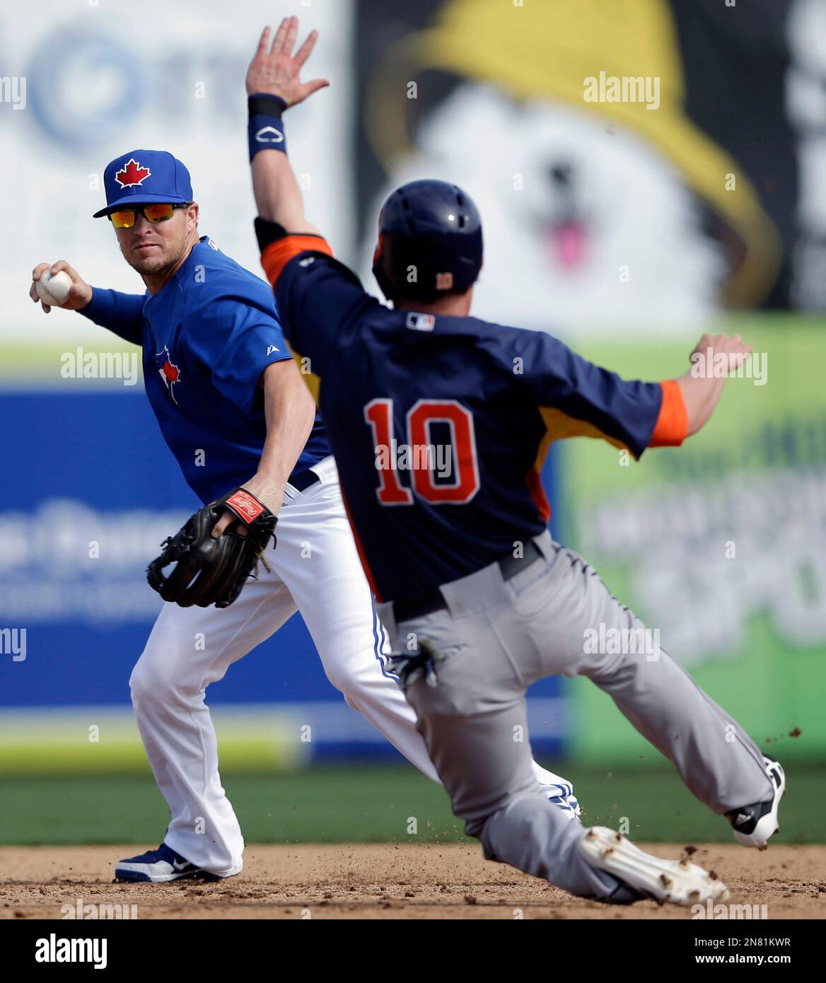Toronto Blue Jays' Mike McCoy, left, throws to first base after forcing ...