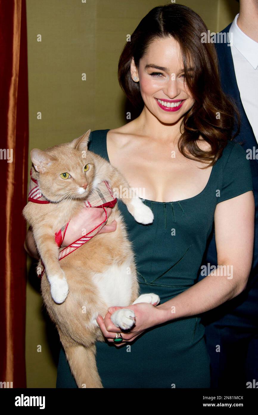 Emilia Clarke poses with a cat from the production at a press event for ...