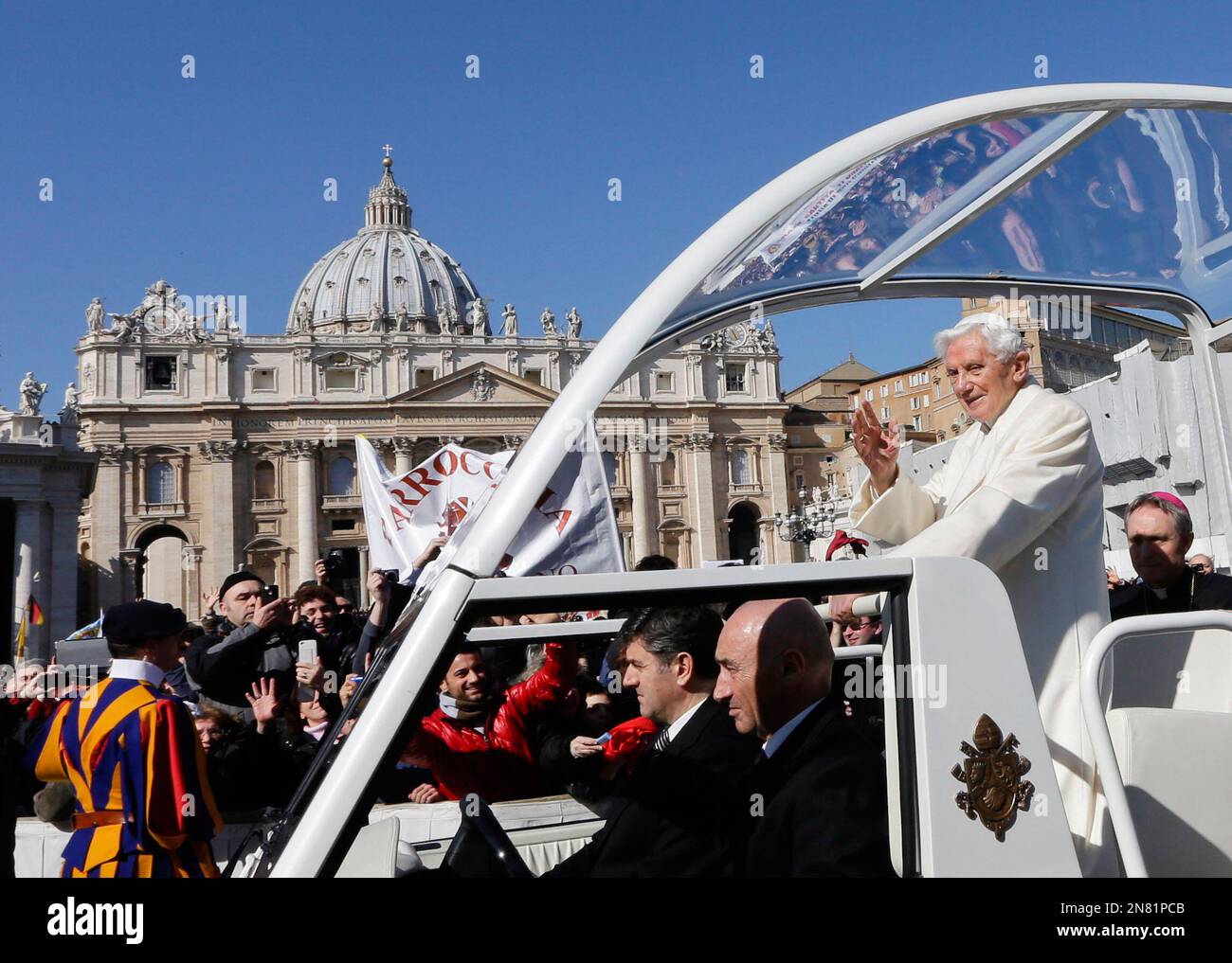 Pope Benedict XVI is driven through the crowd in his pope-mobile as he ...