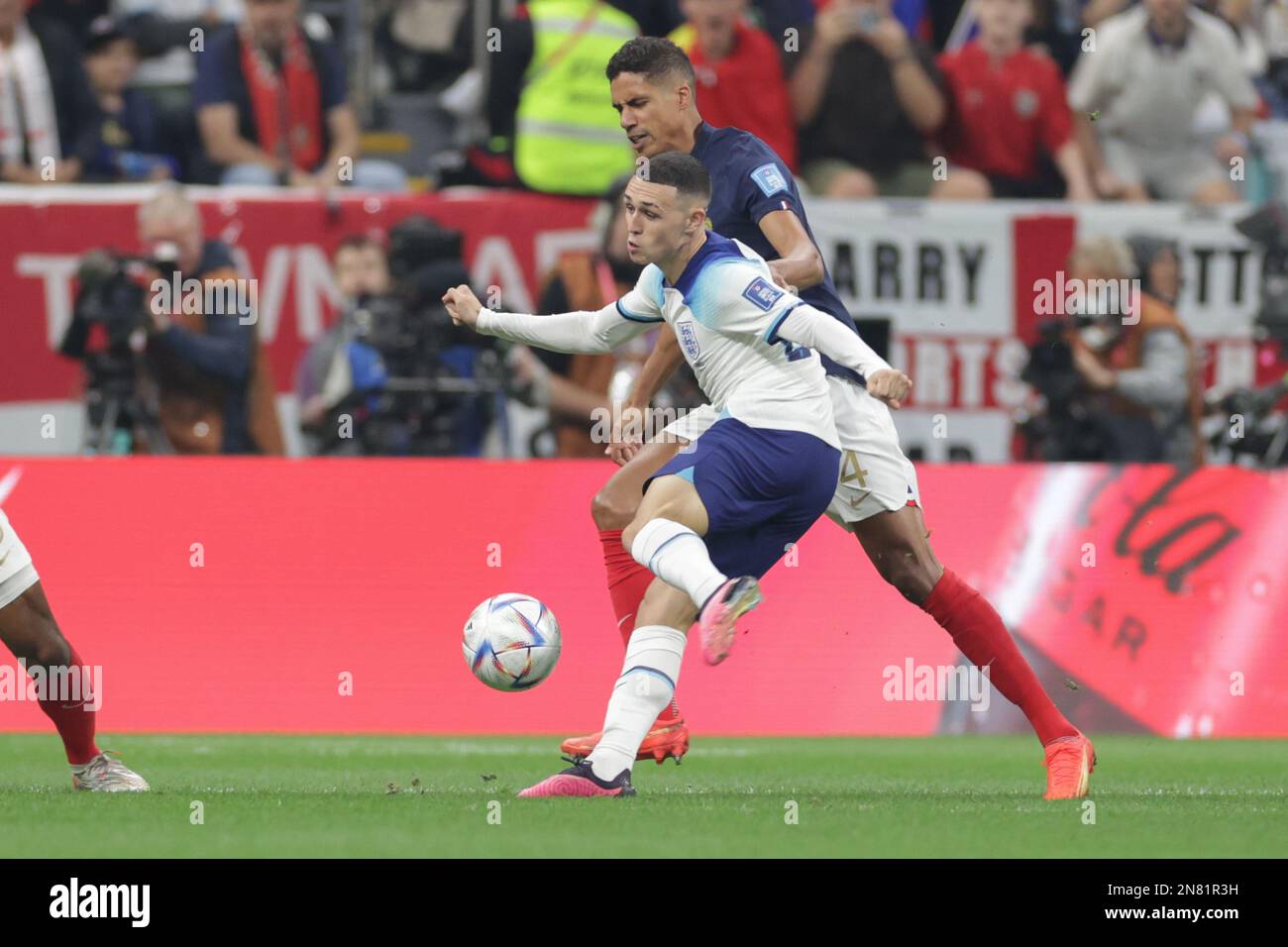 Phil Foden of England (L) and Raphael Varane of France (R) in action ...