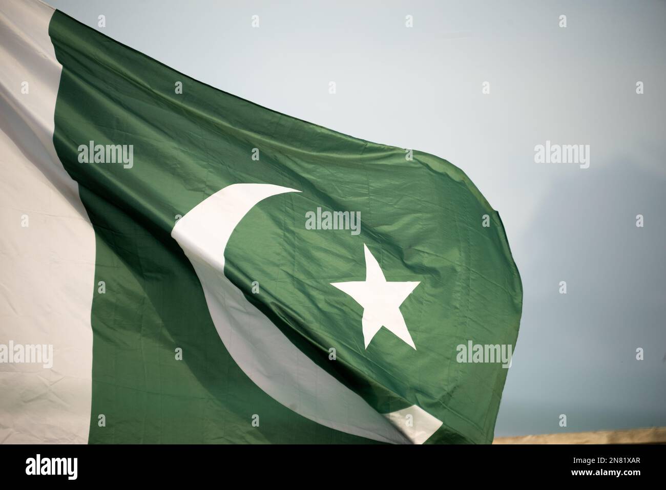 The national flag of Pakistan flies in the blue sky with clouds Stock ...