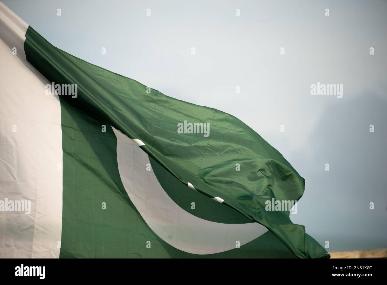 The national flag of Pakistan flies in the blue sky with clouds Stock ...