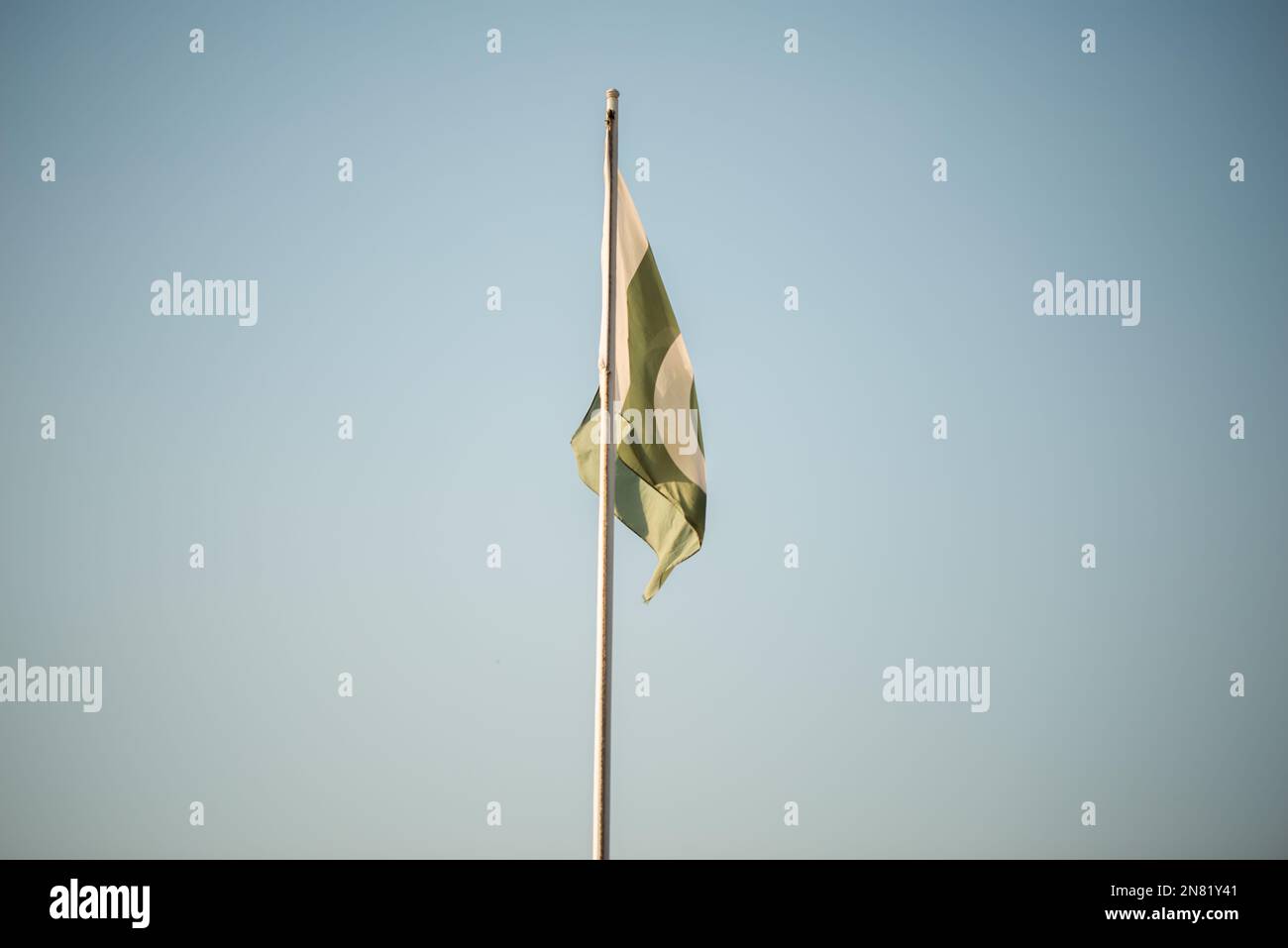 The national flag of Pakistan flies in the blue sky with clouds Stock ...