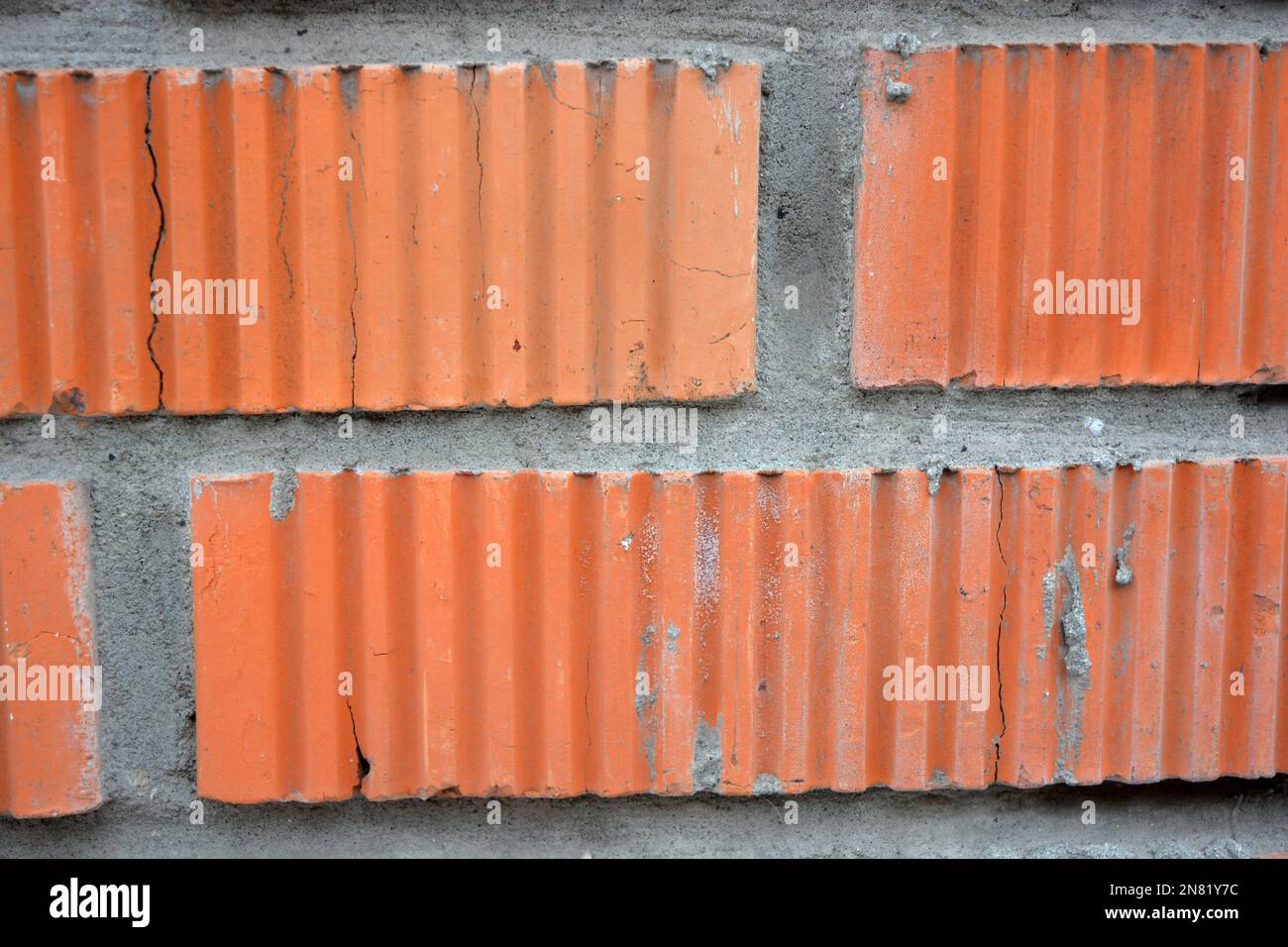 Building background, red beautiful brick wall with grooved sides ...