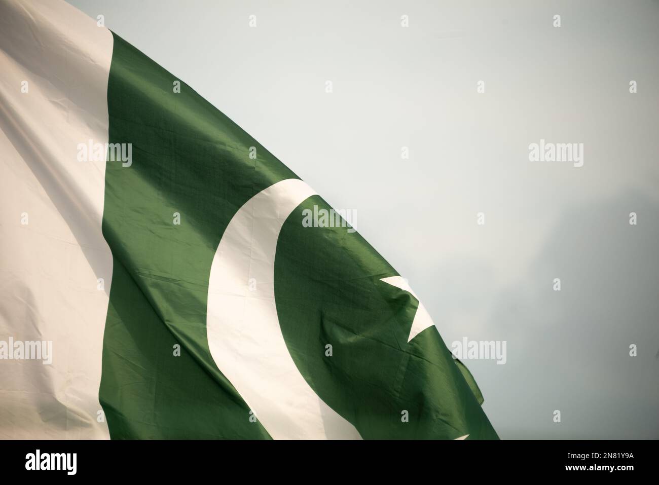 The national flag of Pakistan flies in the blue sky with clouds Stock ...